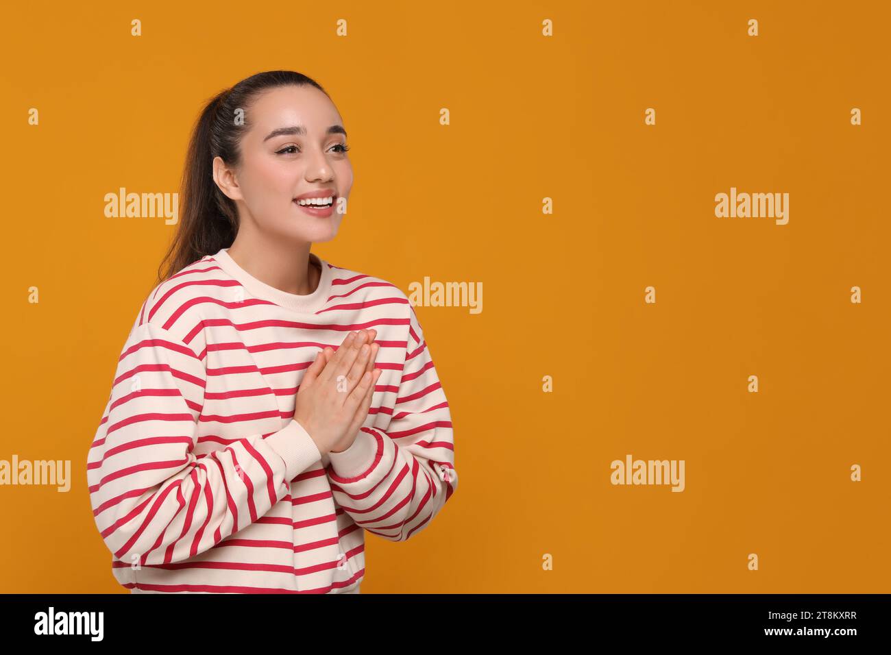 Thank you gesture. Beautiful grateful woman with hands clasped together ...