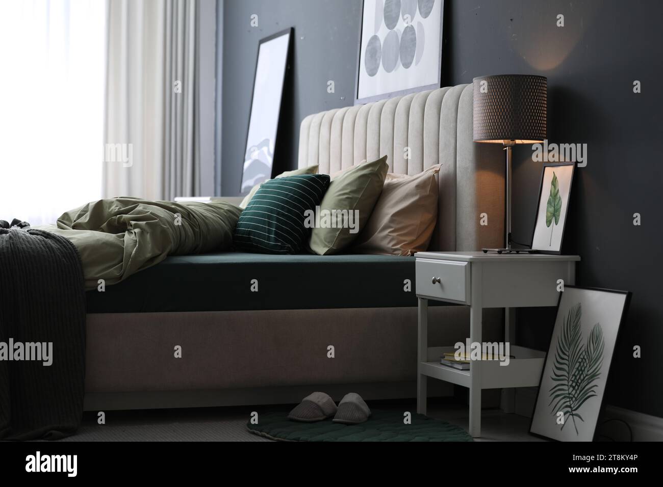 Comfortable bed with new pistachio linens in modern room interior Stock ...