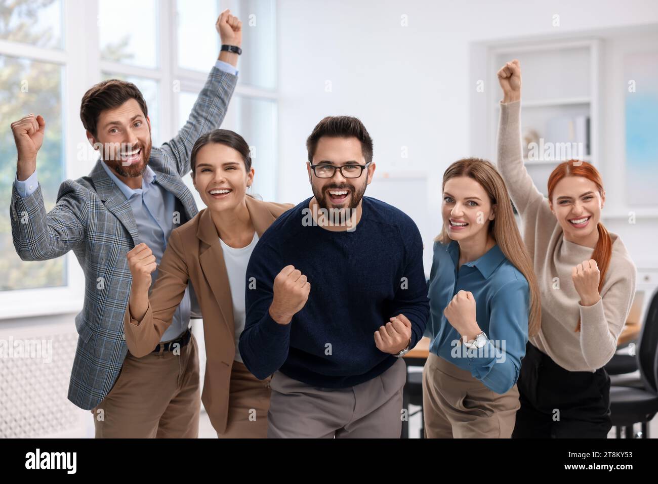 Team of employees celebrating success in office Stock Photo - Alamy