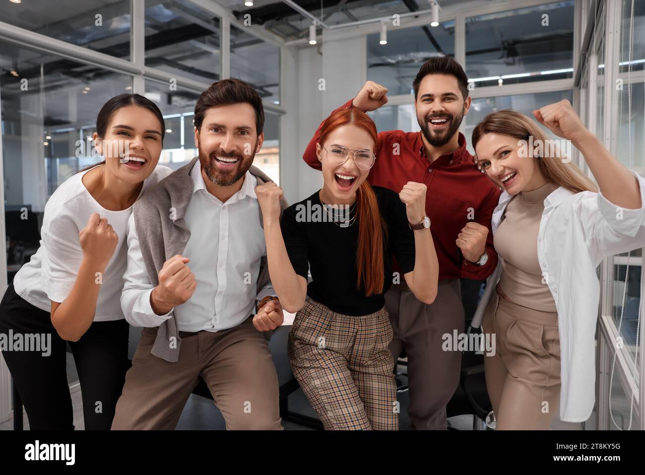 Team of employees celebrating success in office Stock Photo - Alamy
