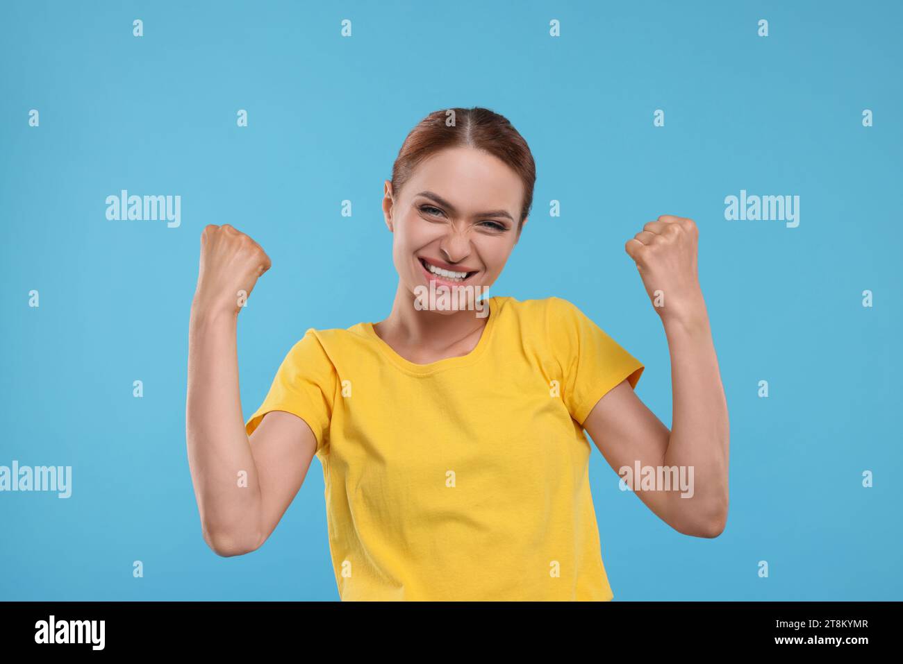Happy fan celebrating on light blue background Stock Photo - Alamy