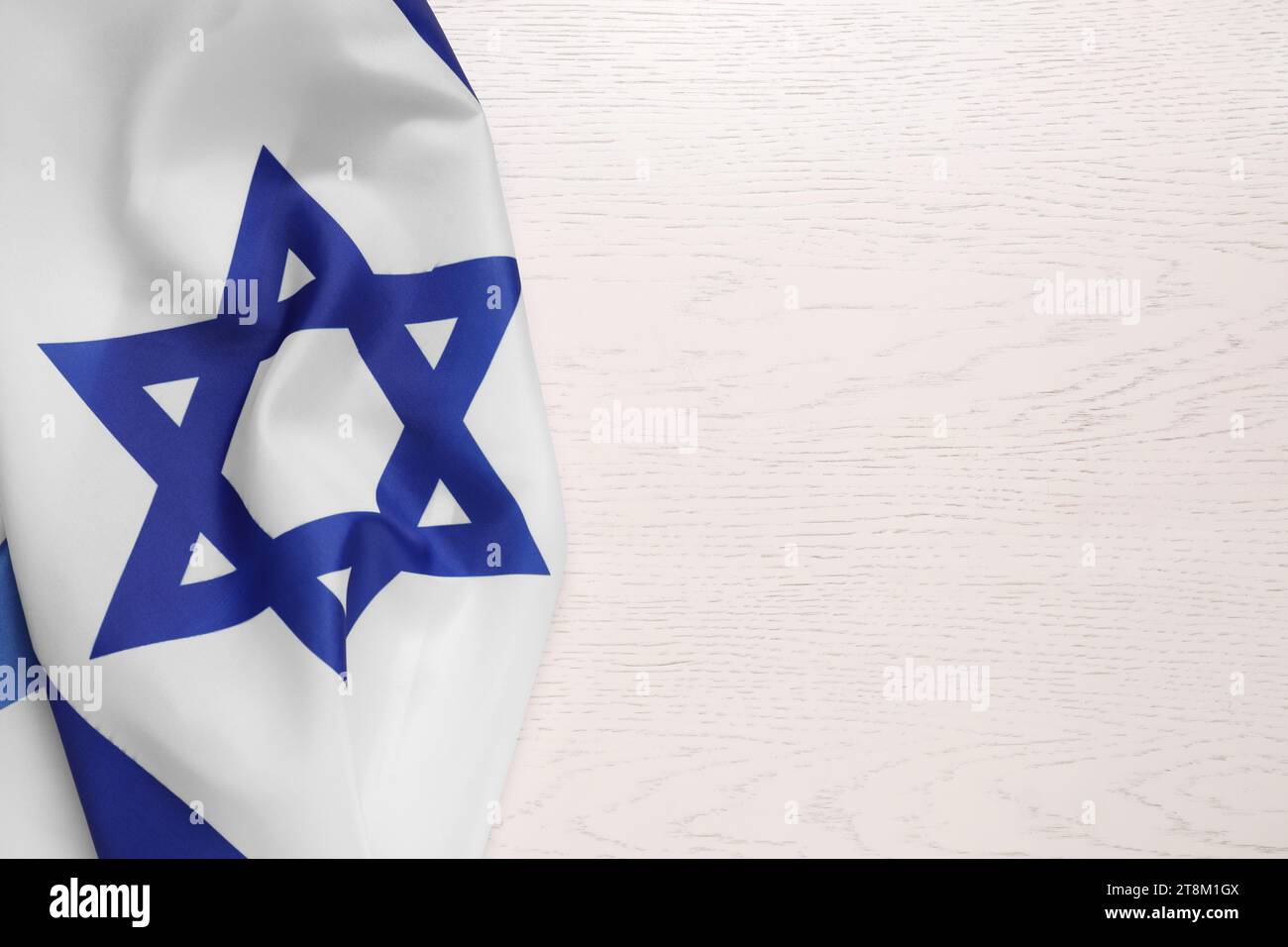 Flag of Israel on white wooden background, top view and space for text ...