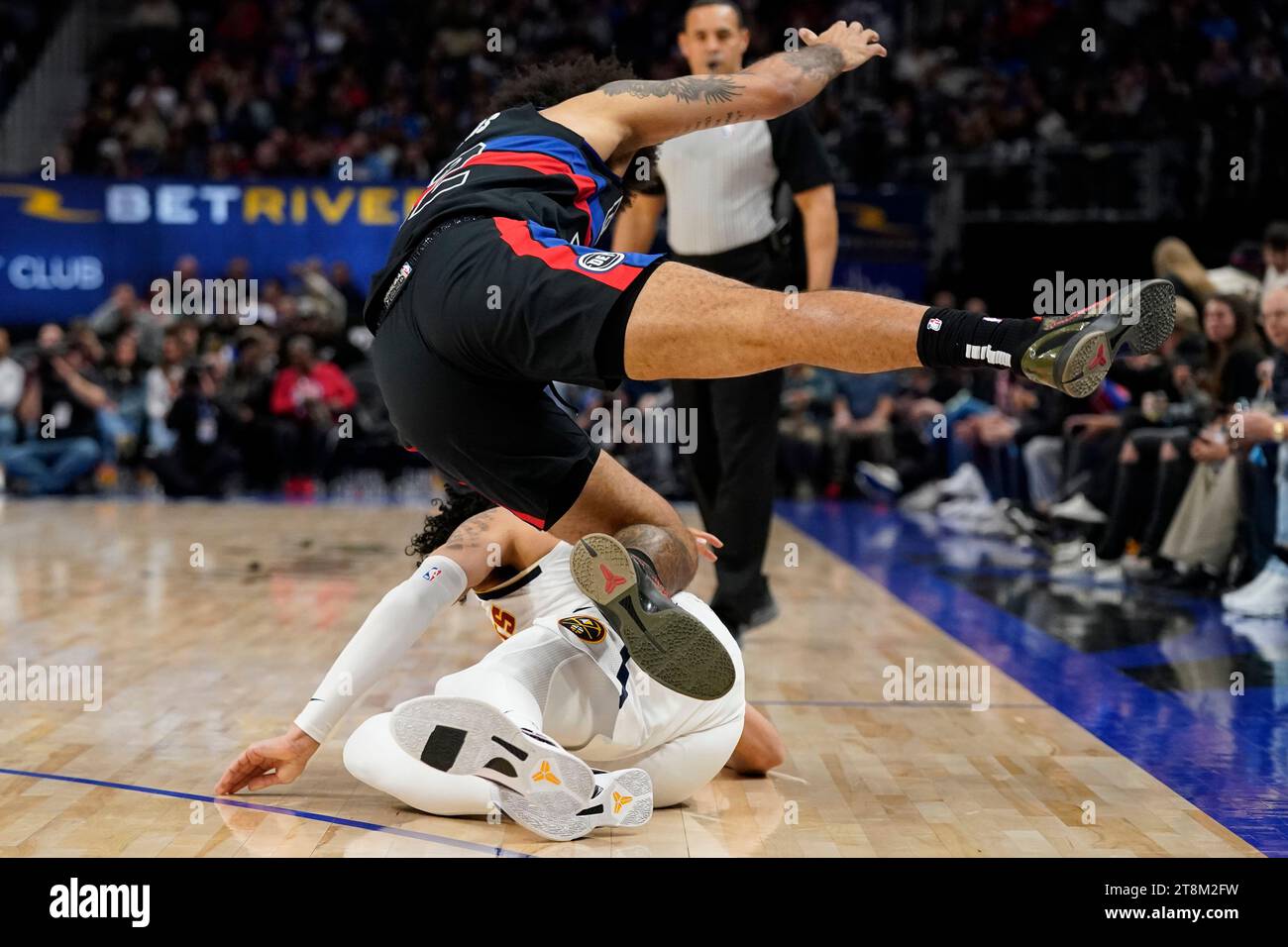 Detroit Pistons forward Isaiah Livers jumps over Denver Nuggets guard ...