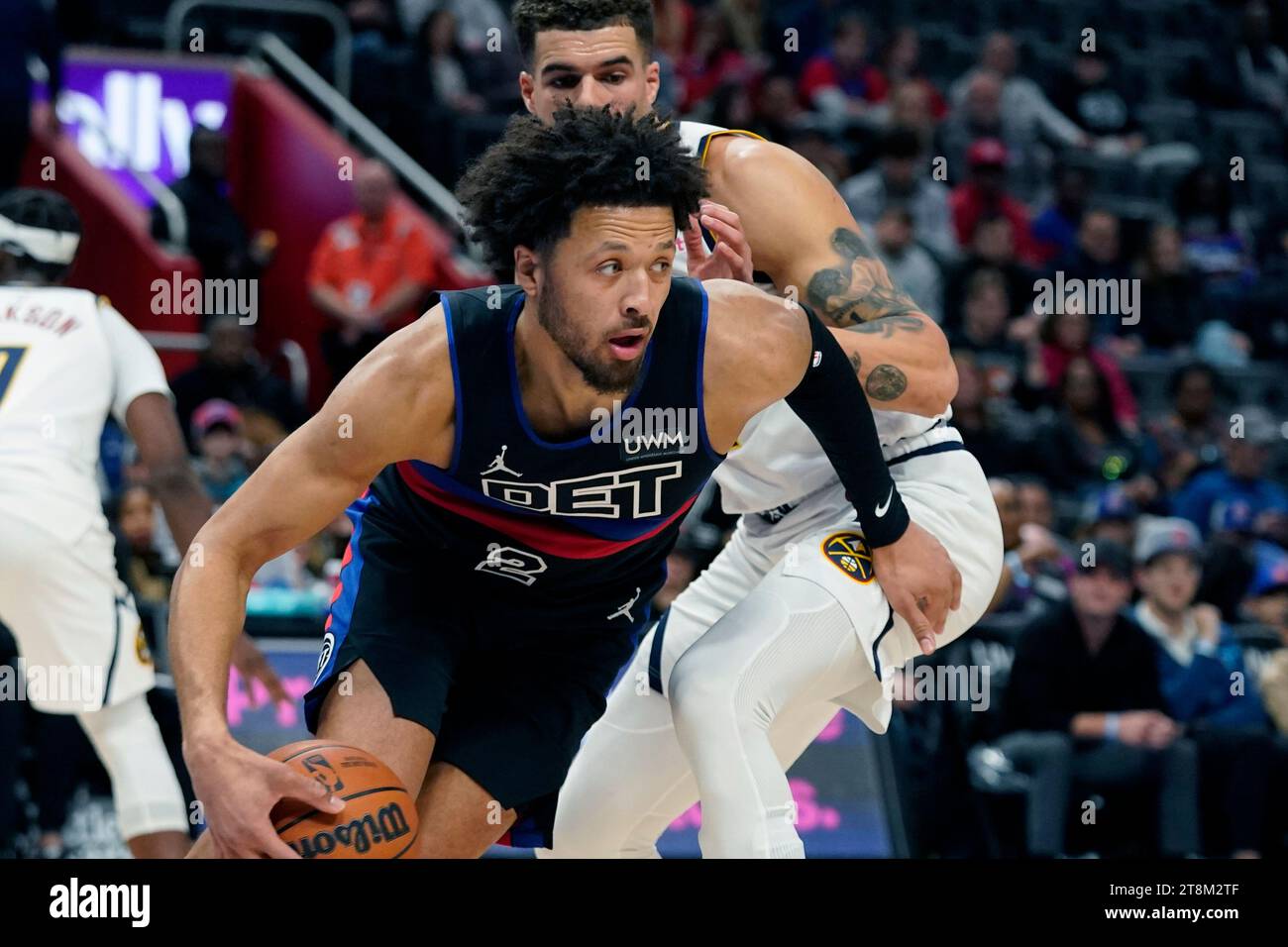 Detroit Pistons guard Cade Cunningham (2) drives around Denver Nuggets ...