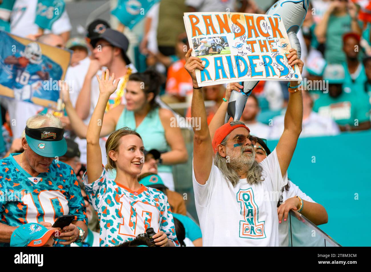 Miami Dolphins fans hold up signs in the stands during an NFL football ...