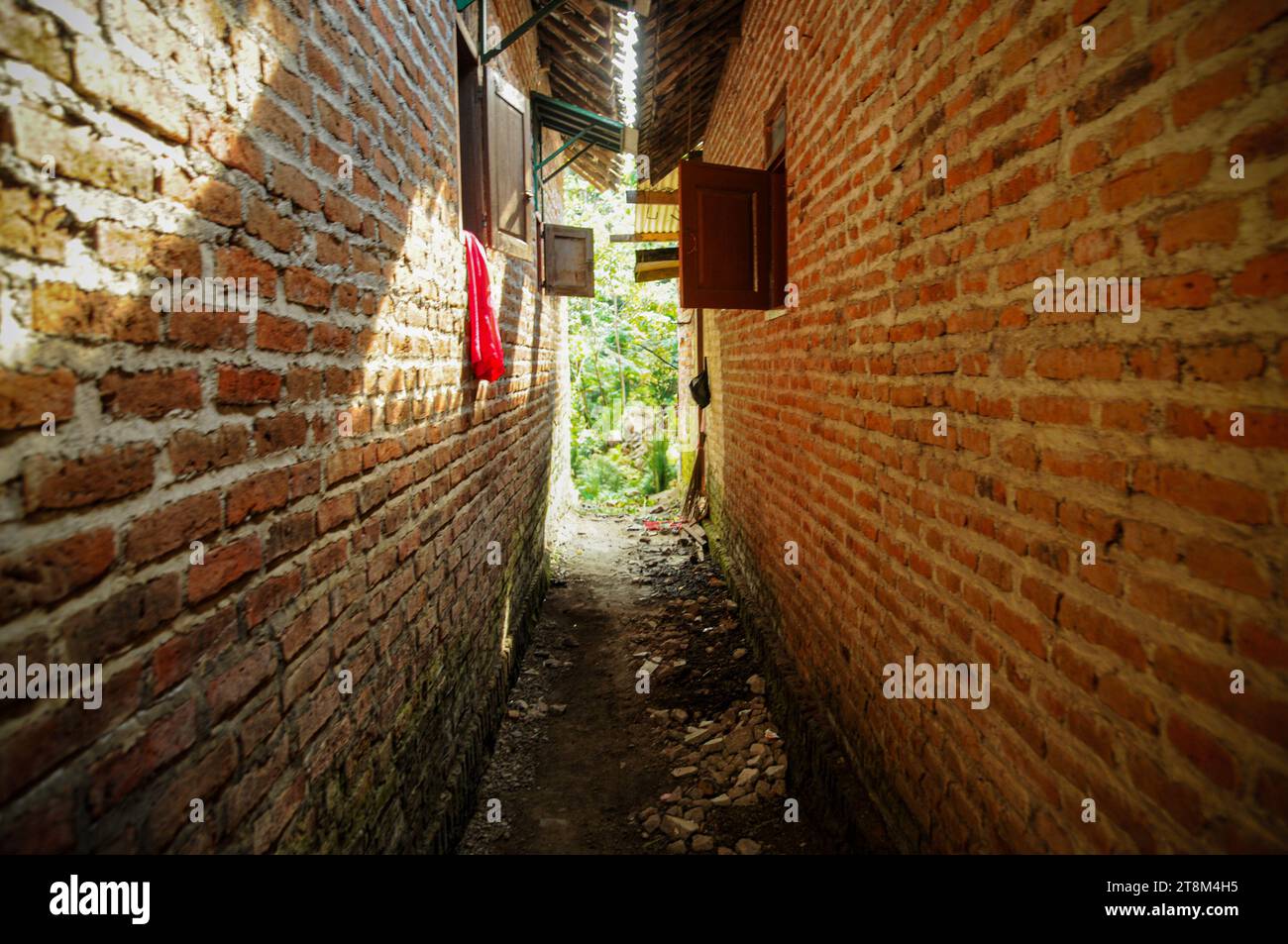 narrow alley between two houses in the village Stock Photo - Alamy