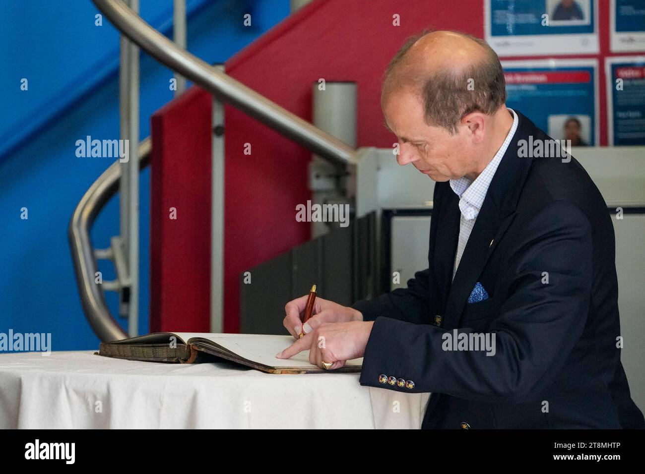 Britain's Prince Edward, the Duke of Edinburgh, signs the visitors book ...