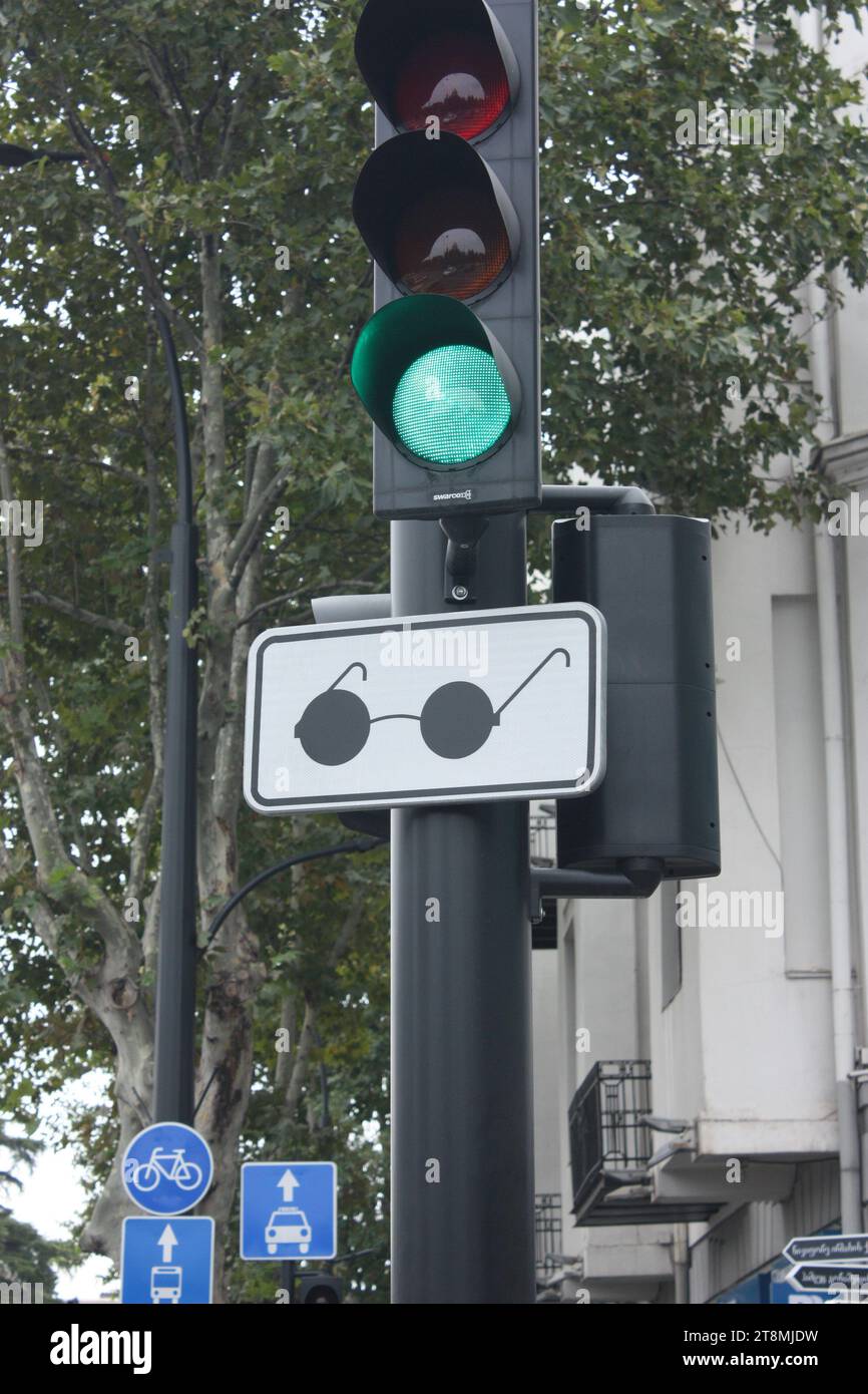 A sign at a set of traffic lights indicating blind people can cross ...