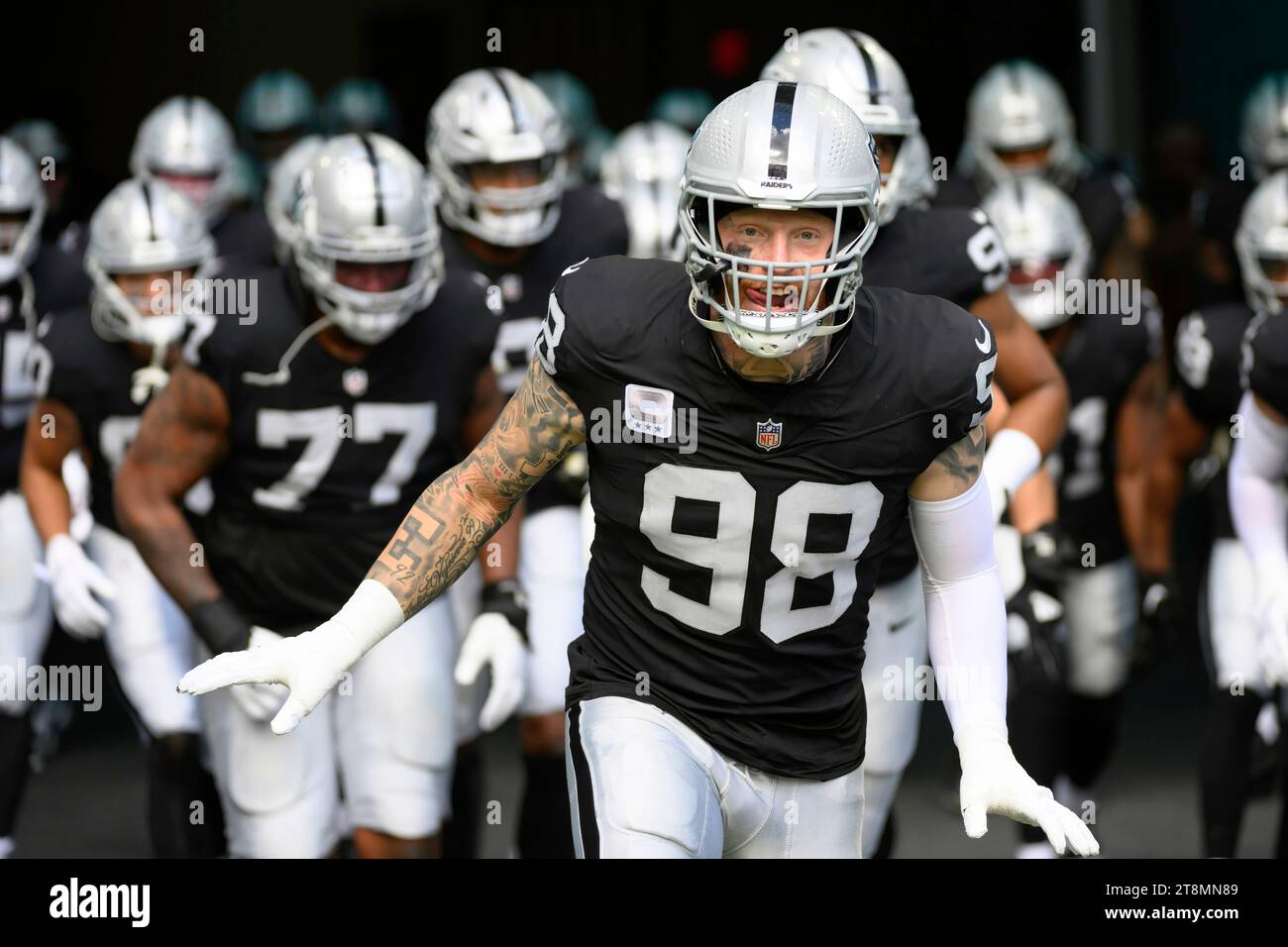 Las Vegas Raiders defensive end Maxx Crosby (98) gestures as he runs ...