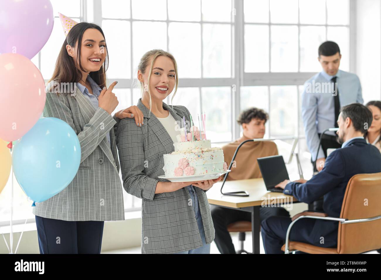Female colleagues with Birthday cake at party in office Stock Photo - Alamy
