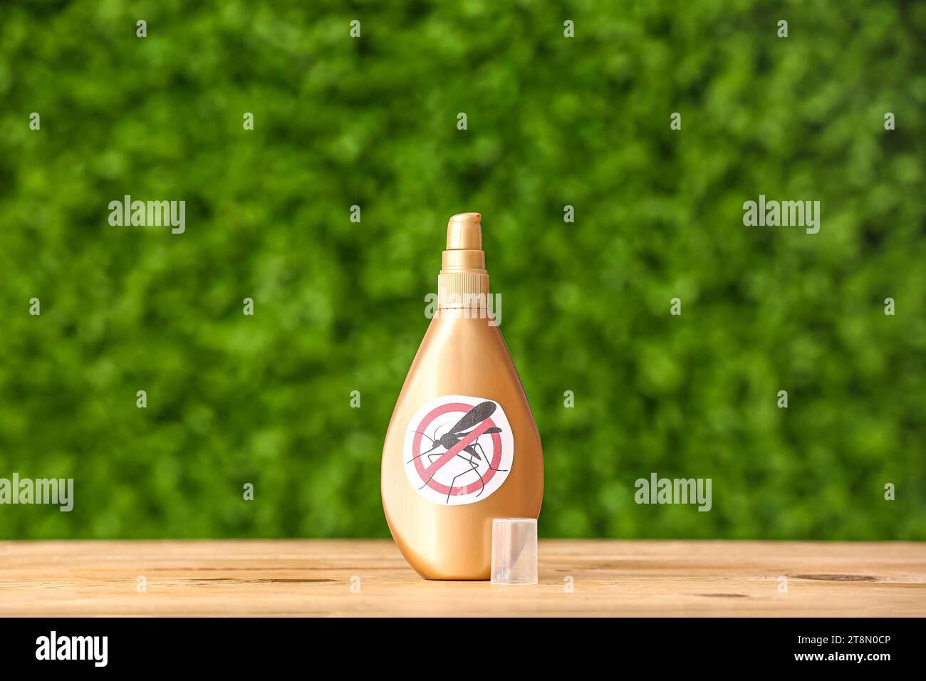 Spray bottle of mosquito repellent on table outdoors Stock Photo - Alamy