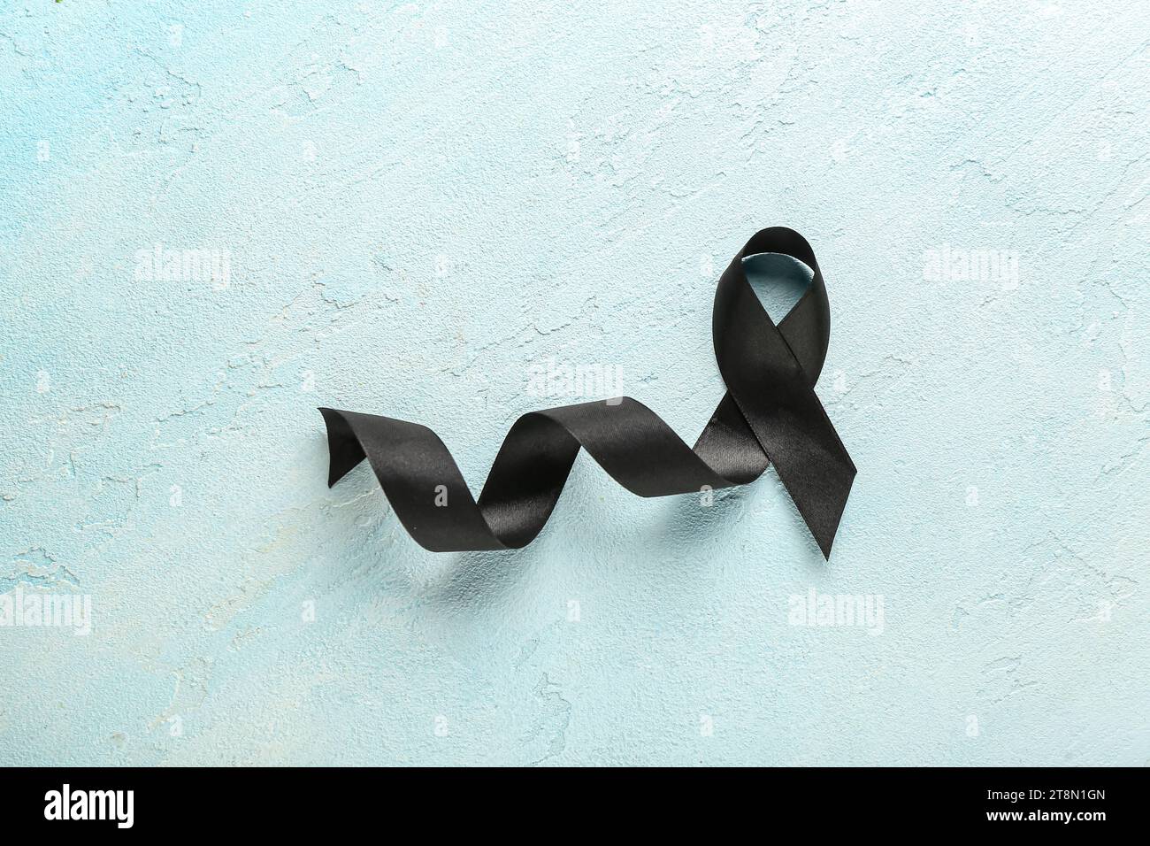 Black funeral ribbon on blue background Stock Photo - Alamy