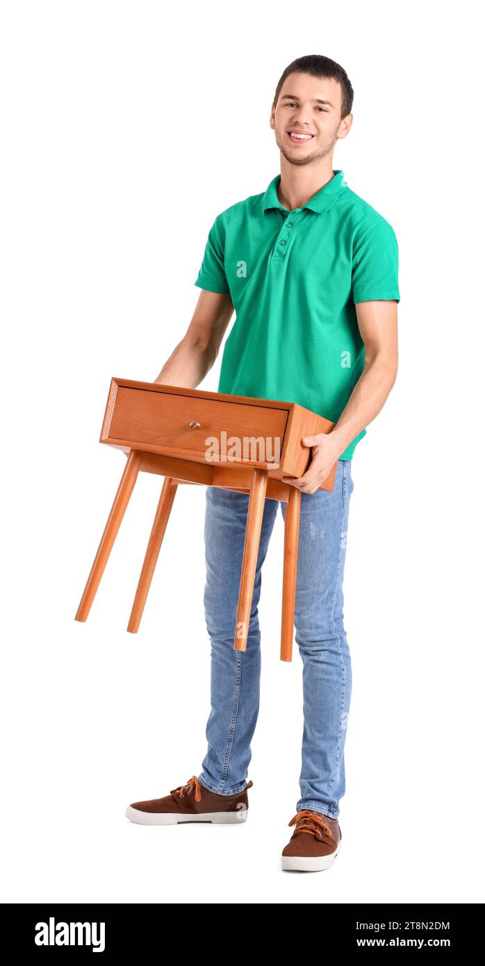 Young loader carrying table on white background Stock Photo - Alamy