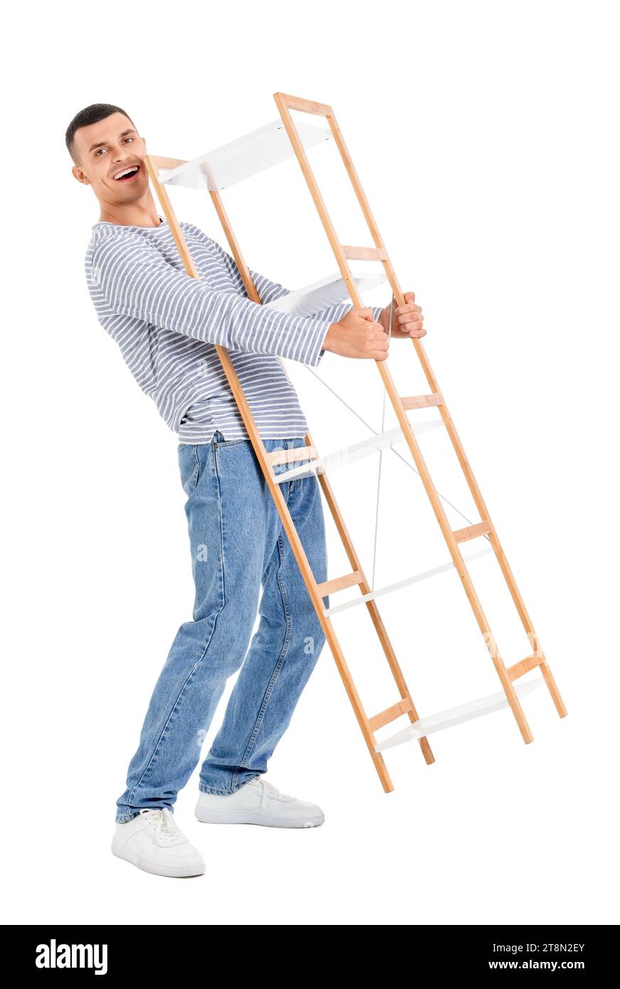 Young man carrying shelf unit on white background Stock Photo - Alamy