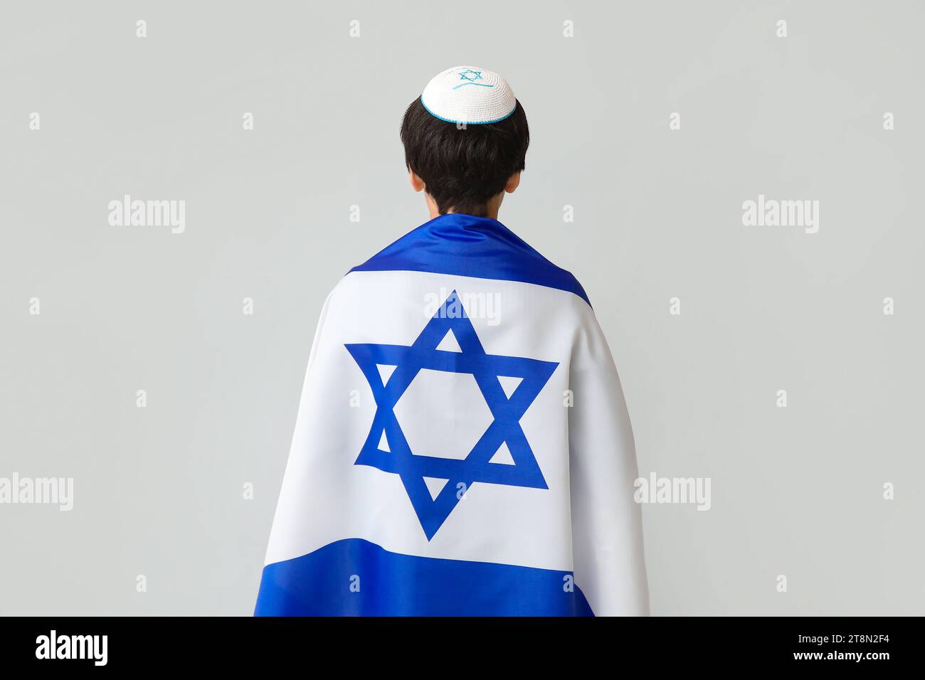 Little boy in kipa with Israel flag on grey background, back view Stock ...