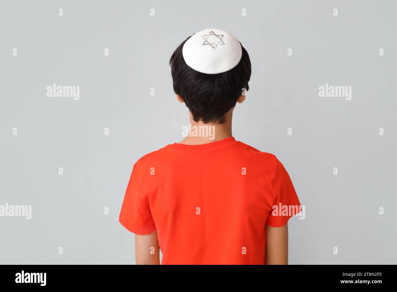 Little Israeli boy in kipa on grey background, back view Stock Photo ...