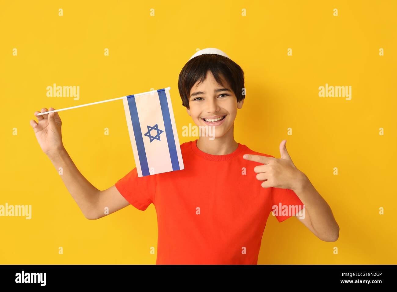 Little boy in kipa pointing at Israel flag on yellow background Stock ...