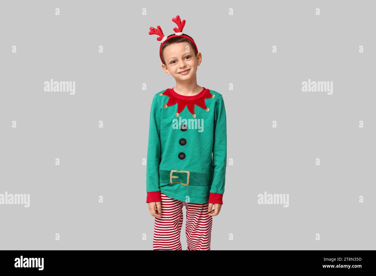 Cute little boy dressed as elf on grey background Stock Photo - Alamy