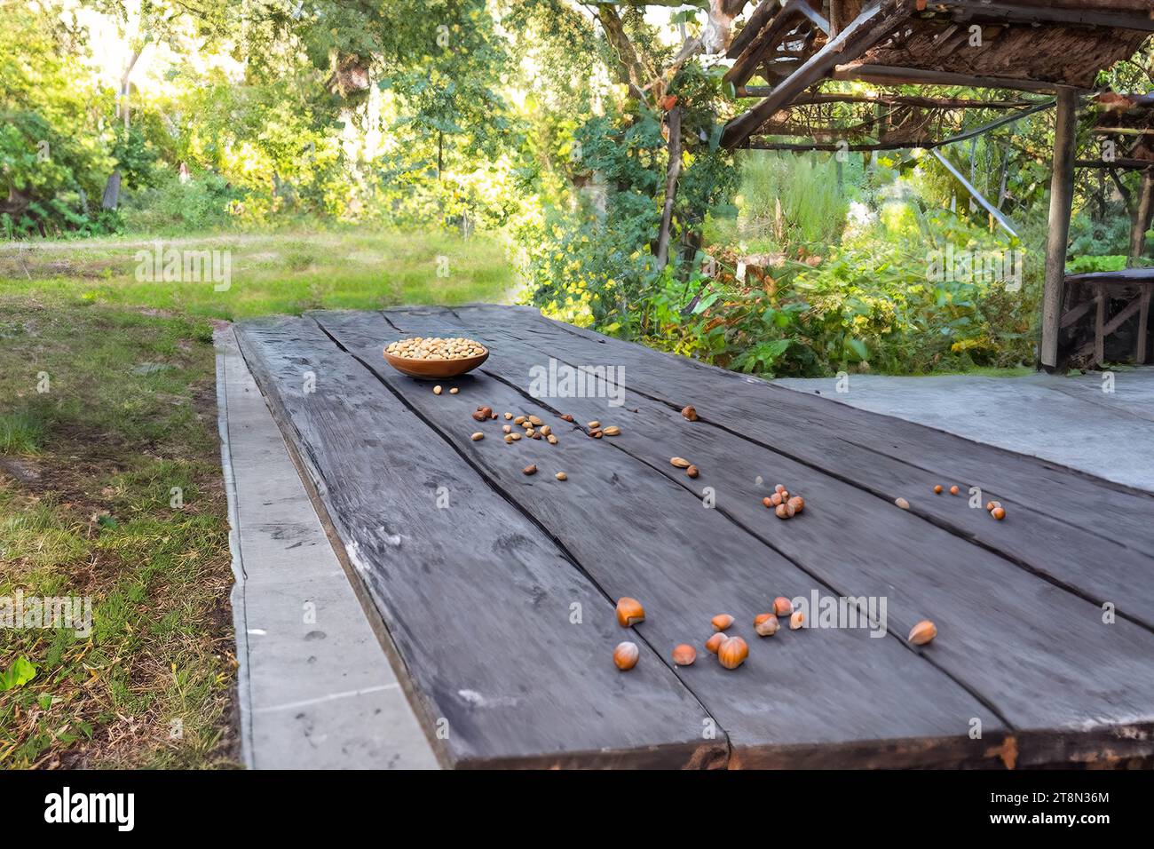 Old table with bowl and nuts Stock Photo - Alamy
