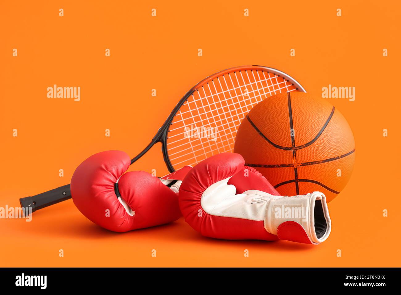 Tennis racket with boxing gloves and ball for playing basketball on ...