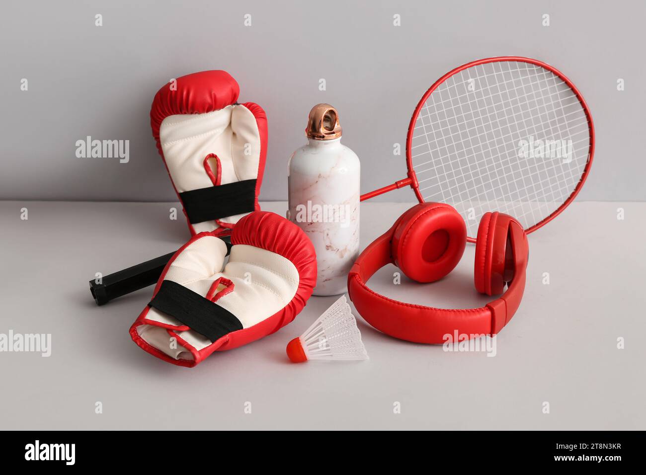 Badminton racket with shuttlecock, boxing gloves, headphones and sports ...
