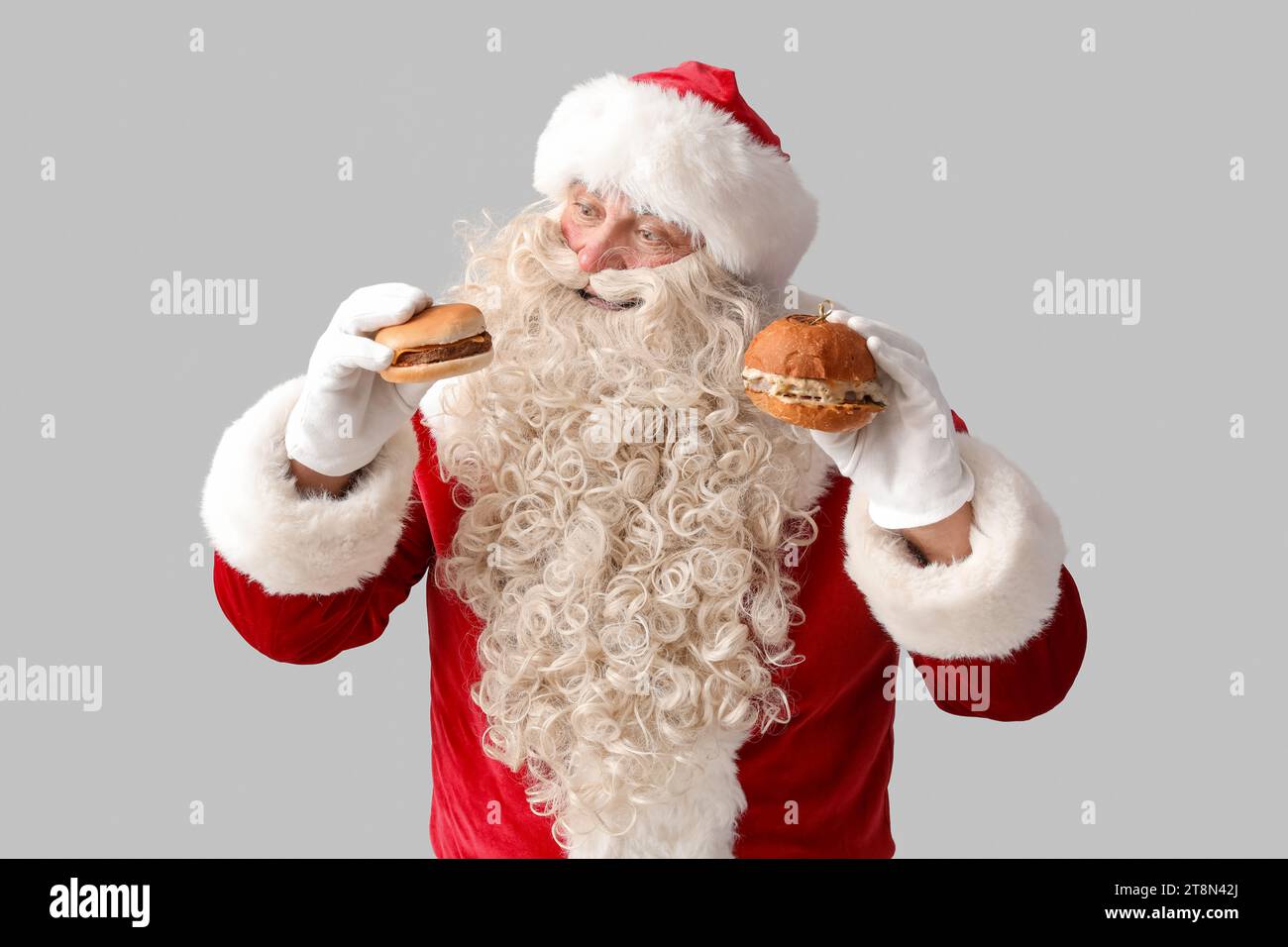 Santa Claus with tasty burgers on white background Stock Photo - Alamy