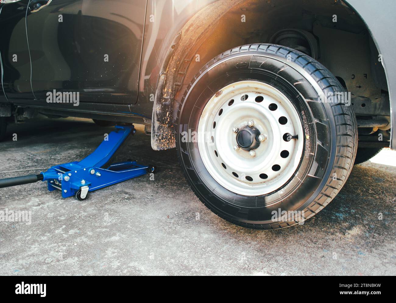 Lifting a pickup truck with a hydraulic floor jack for servicing and ...