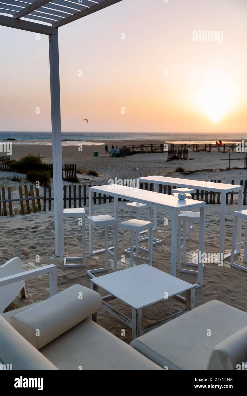 White tables and chairs in the sand, lounge bar, beach bar with a view ...