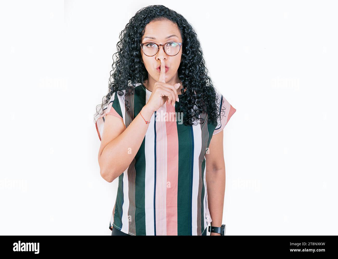 Young woman shushing you with her finger. Afro woman making silence ...