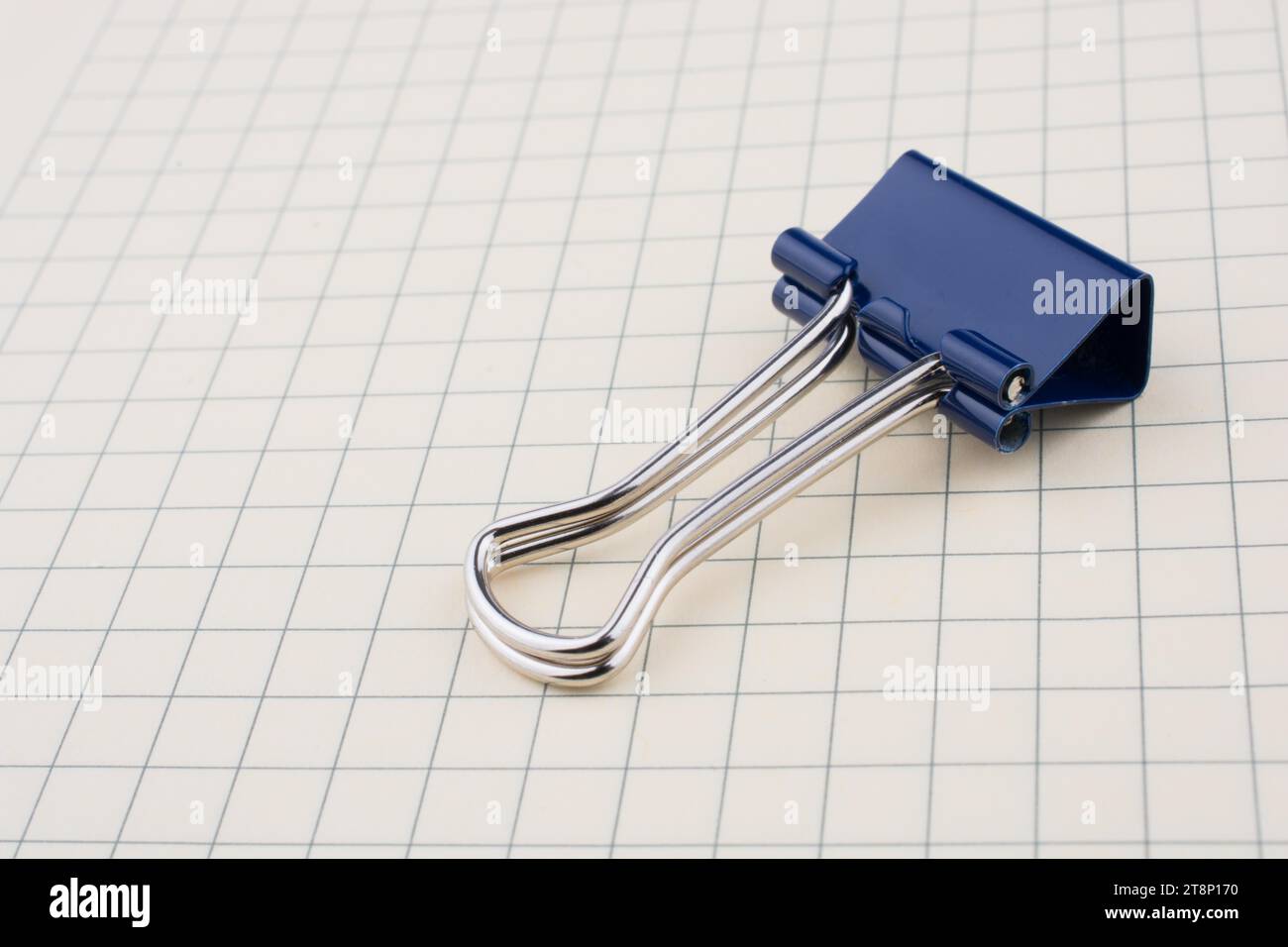 Colored paper clip on a checked notebook page Stock Photo - Alamy