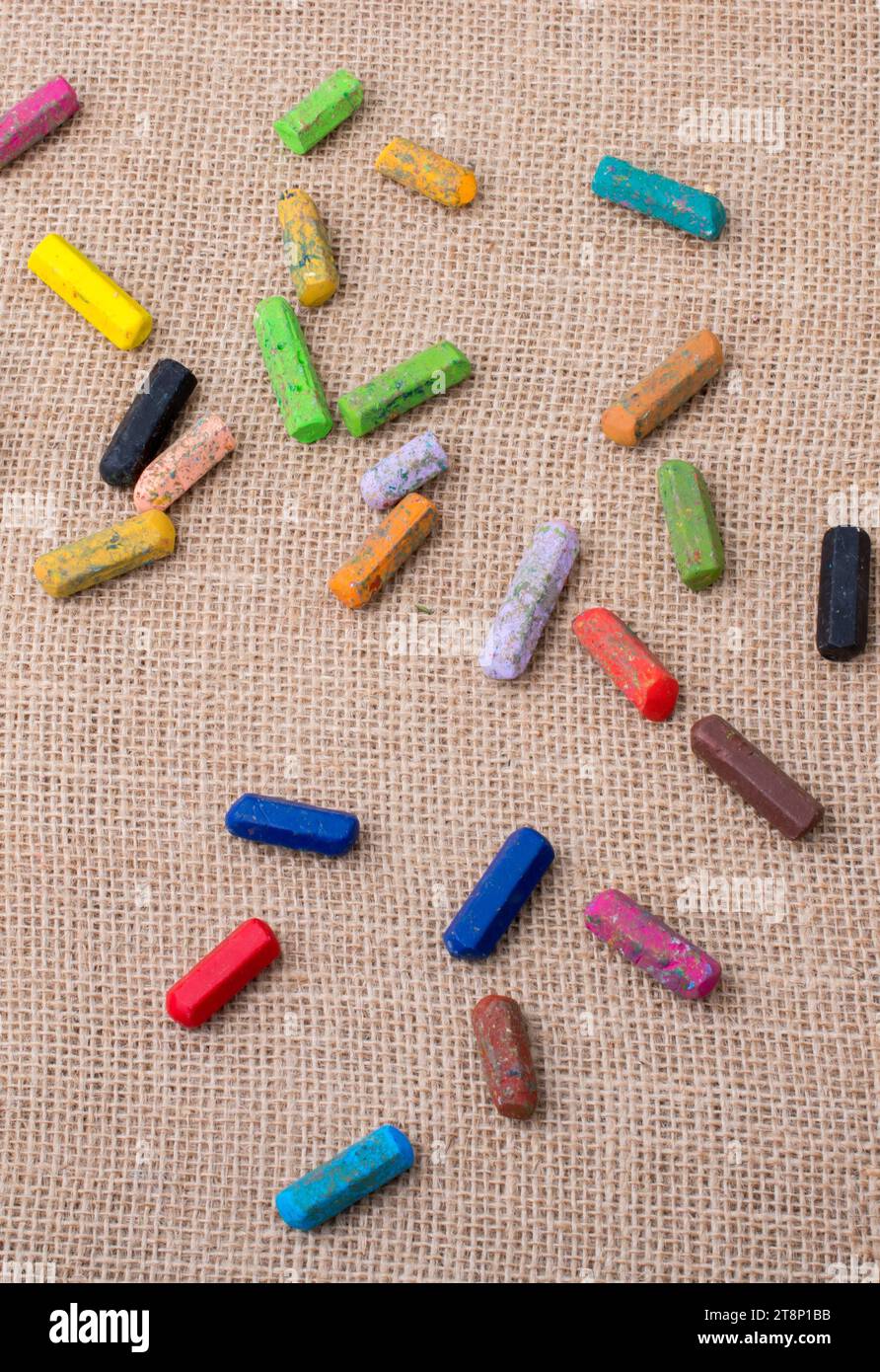Used crayons of various color on a canvas Stock Photo - Alamy