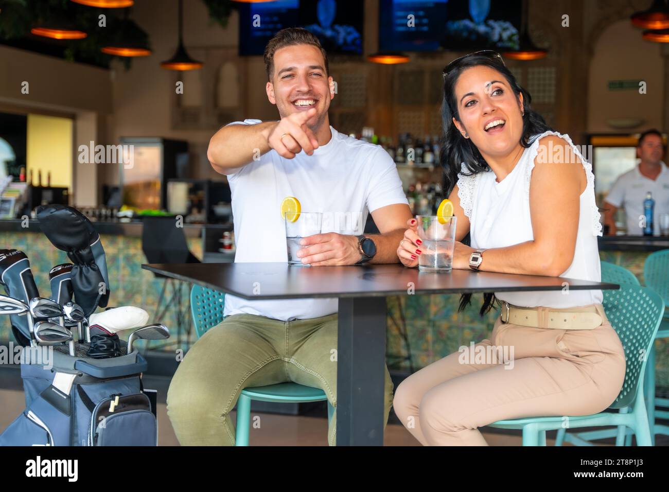 Rich man pointing outside the bar of a golf club chatting with his ...