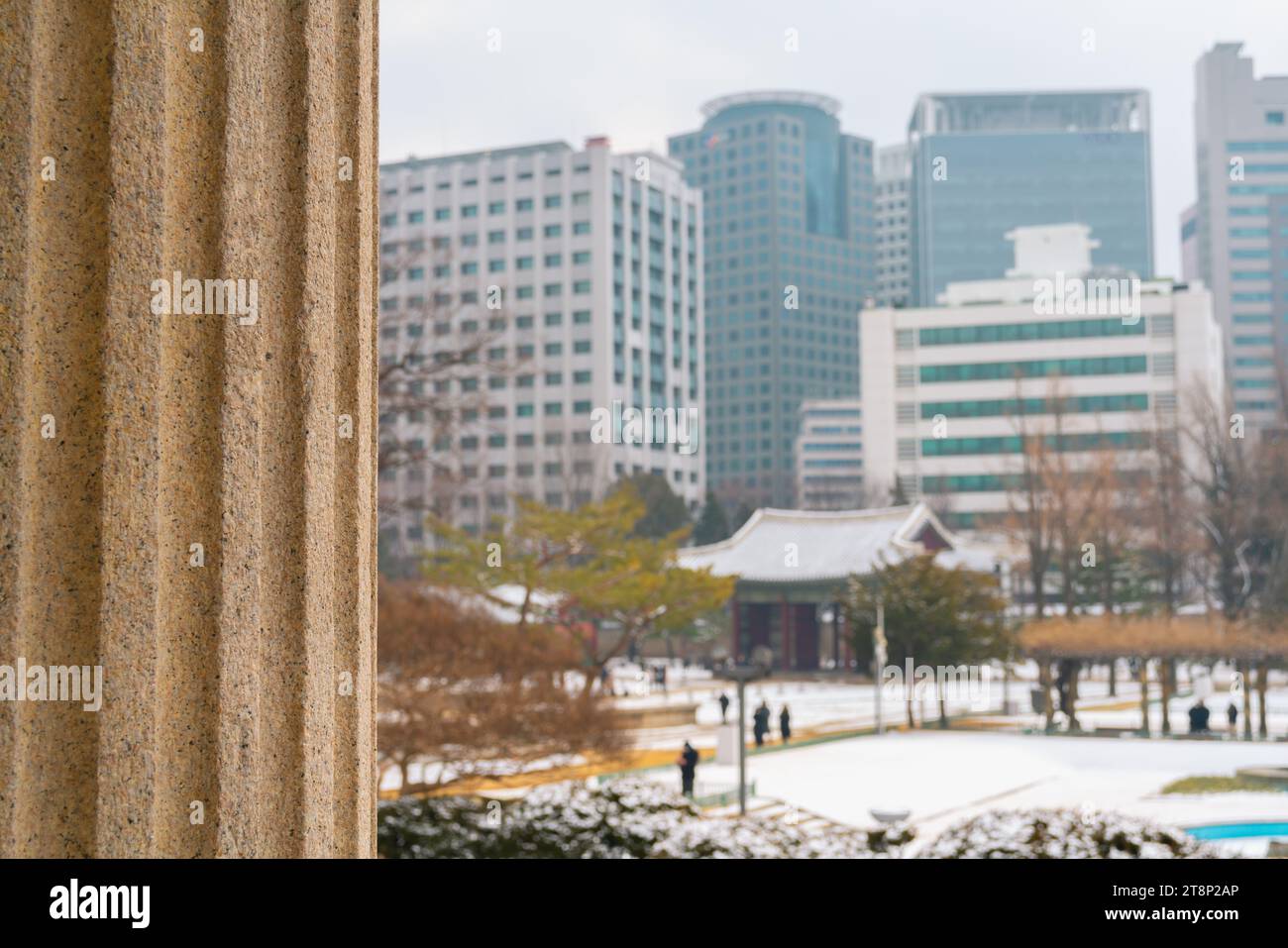 Snowy winter Deoksugung Palace and office buildings in Seoul, Korea ...