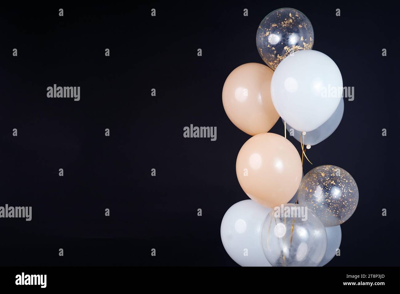 On a black background, balloons of light shades - white, beige ...