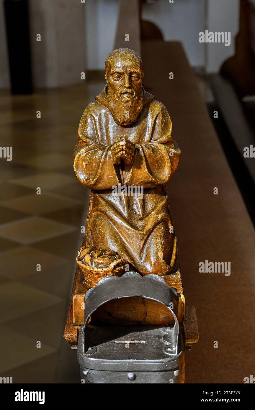 Praying figure on a church bench, in St.Stephan, Minelheim, Bavaria ...
