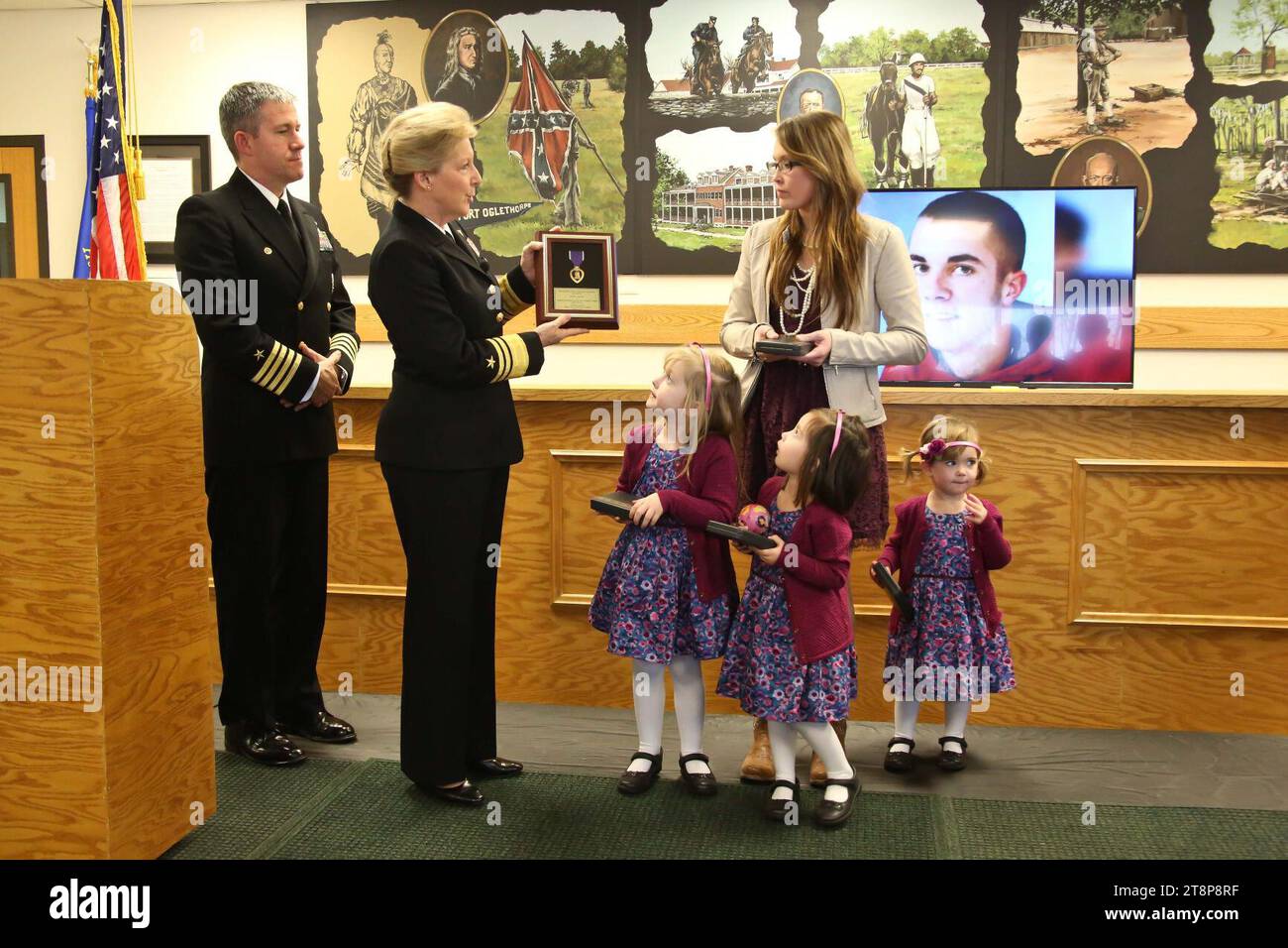 Vice Adm. Robin Braun presents a Purple Heart shadow box to the widow ...