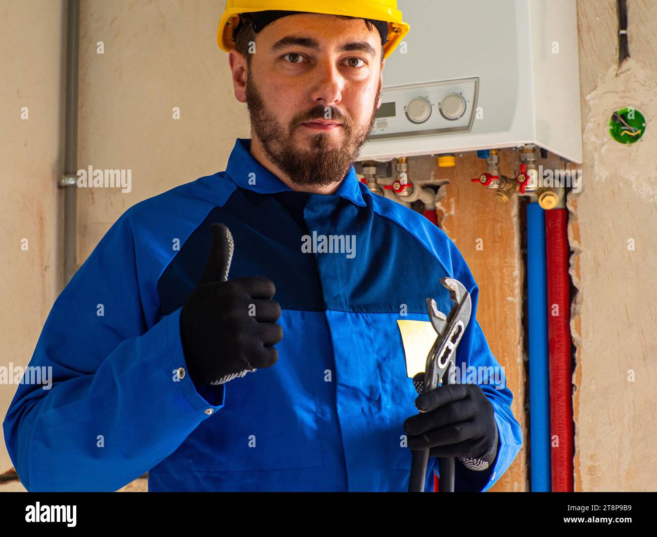 Portrait of worker or engineer in blue work clothes and yellow safety ...