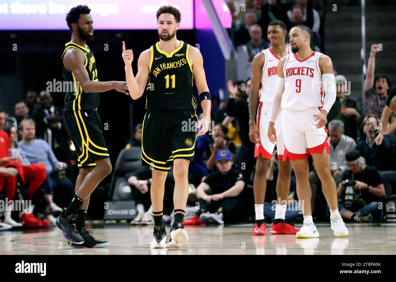 Golden State Warriors' Klay Thompson reacts to one of his 3-pointers with teammate Andrew ...