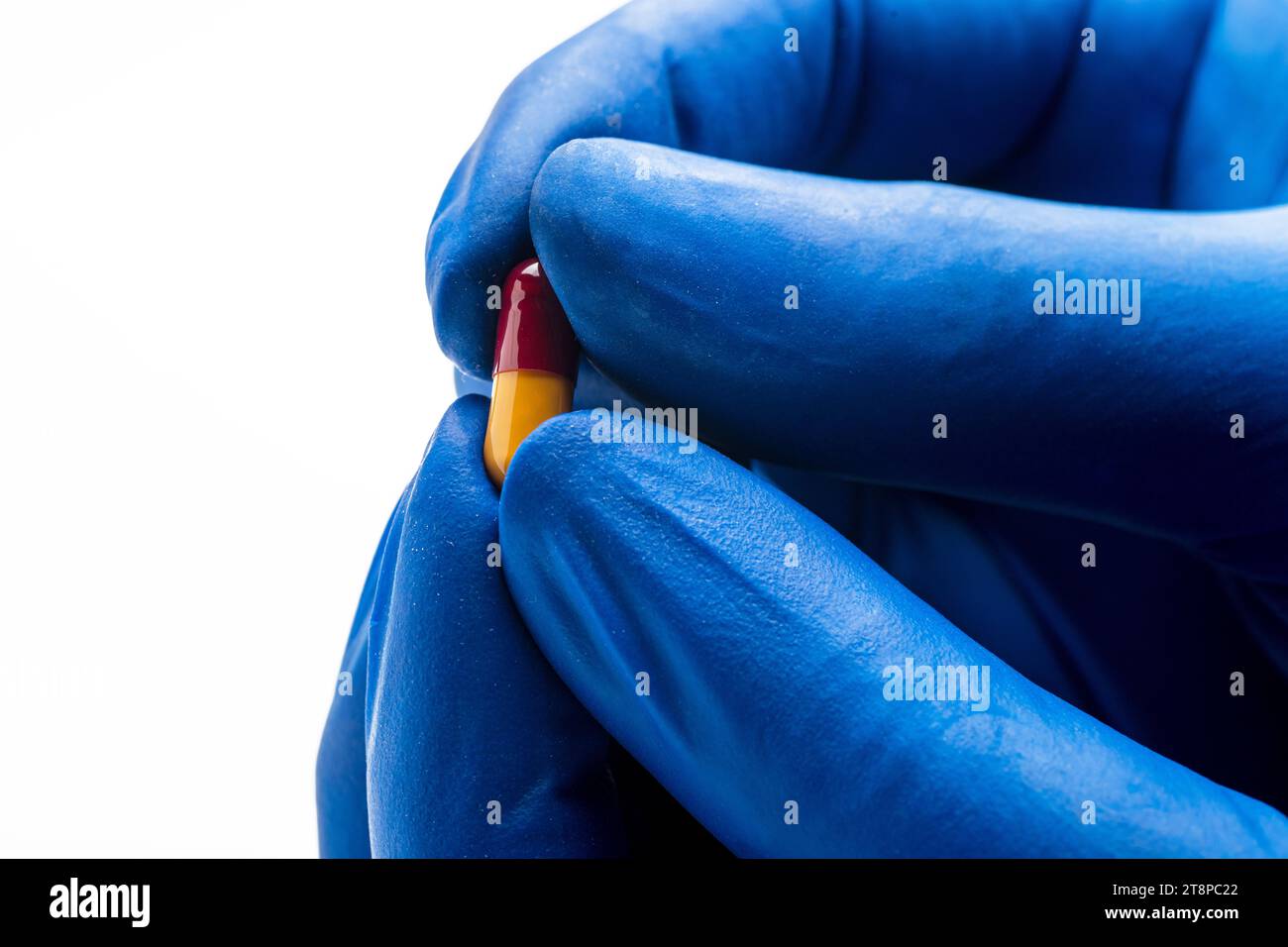 Hand with medical glove break the pill isolated over white background ...