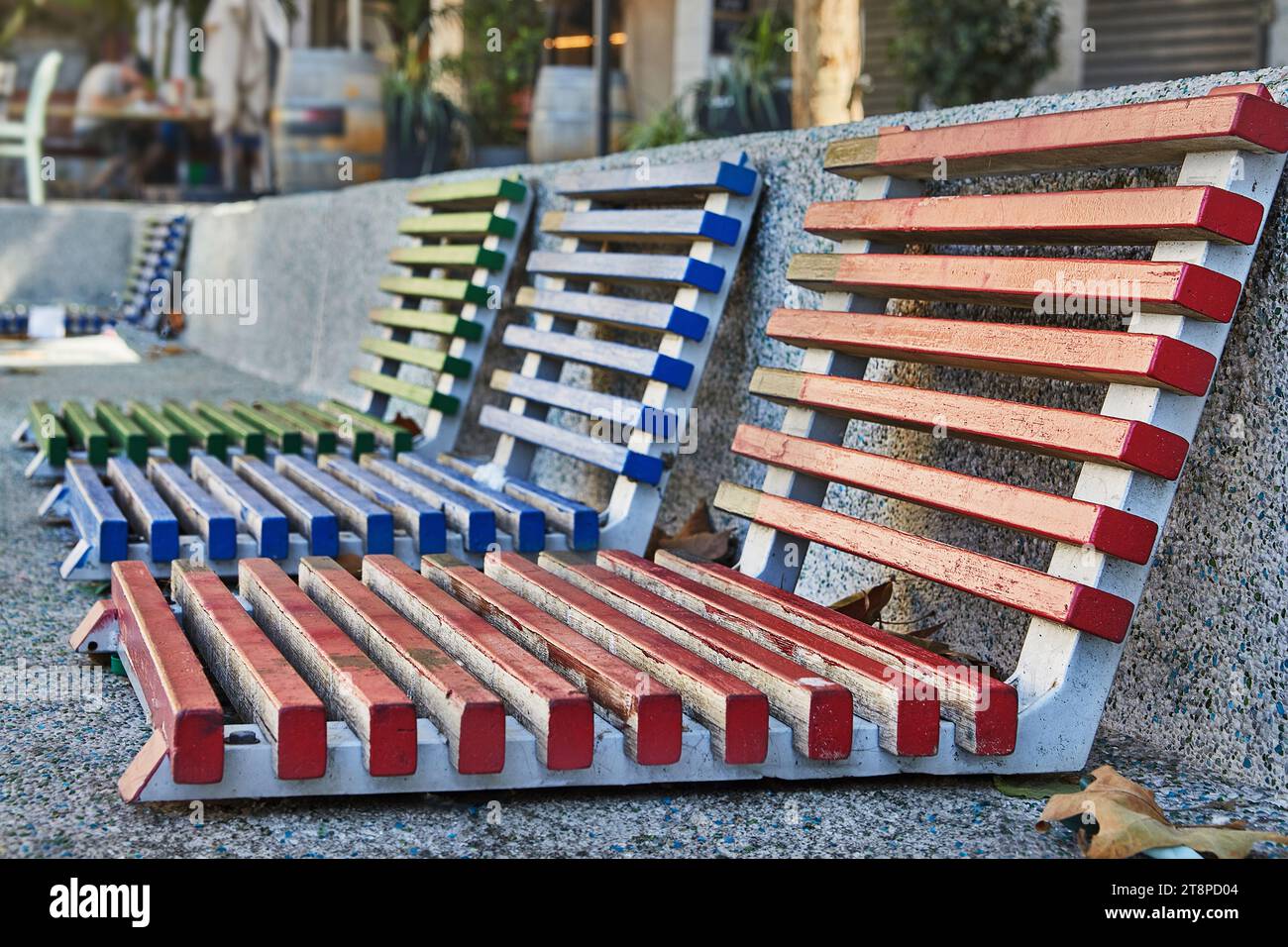 Colored benches in the city square. Musical concept Stock Photo - Alamy