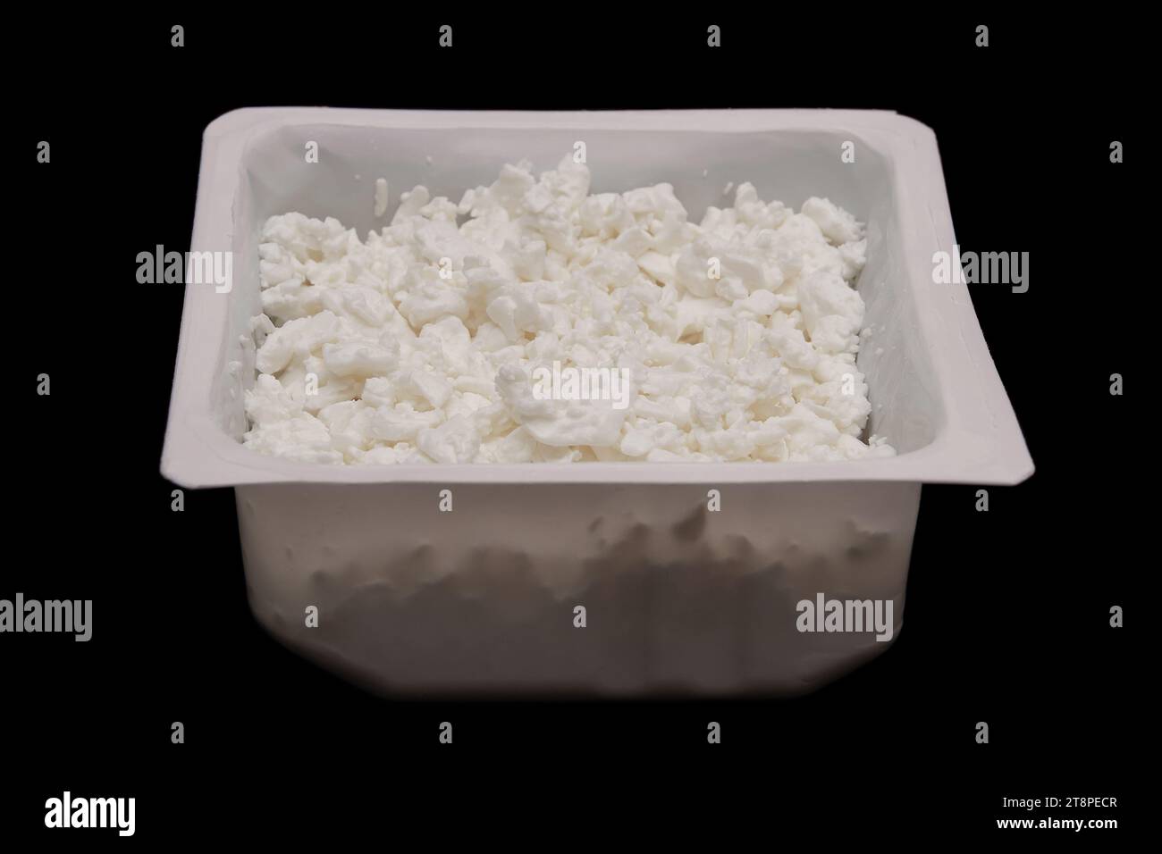 Cottage cheese in container isolated on black background. Side view ...