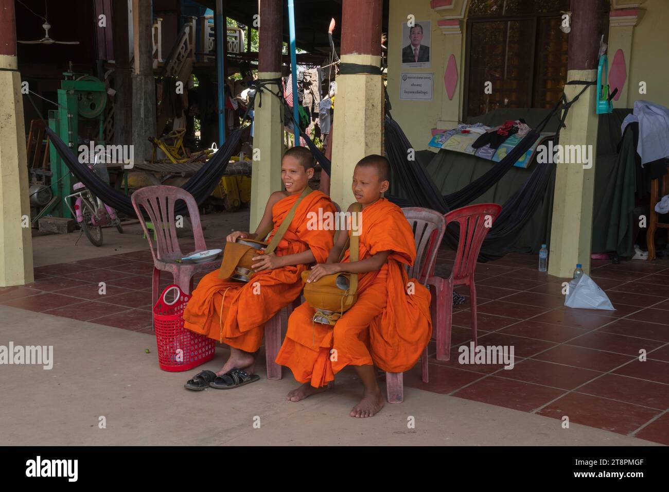 Two buddhist monks getting food from locals Stock Photo - Alamy