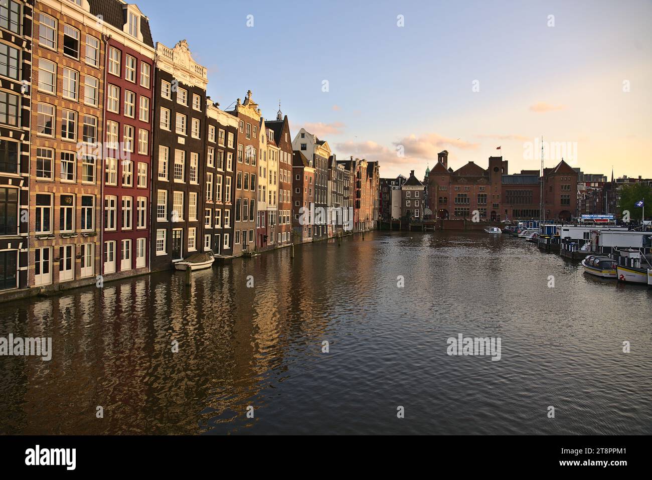 A scenic view of a canal along beautiful buildings in Amsterdam ...