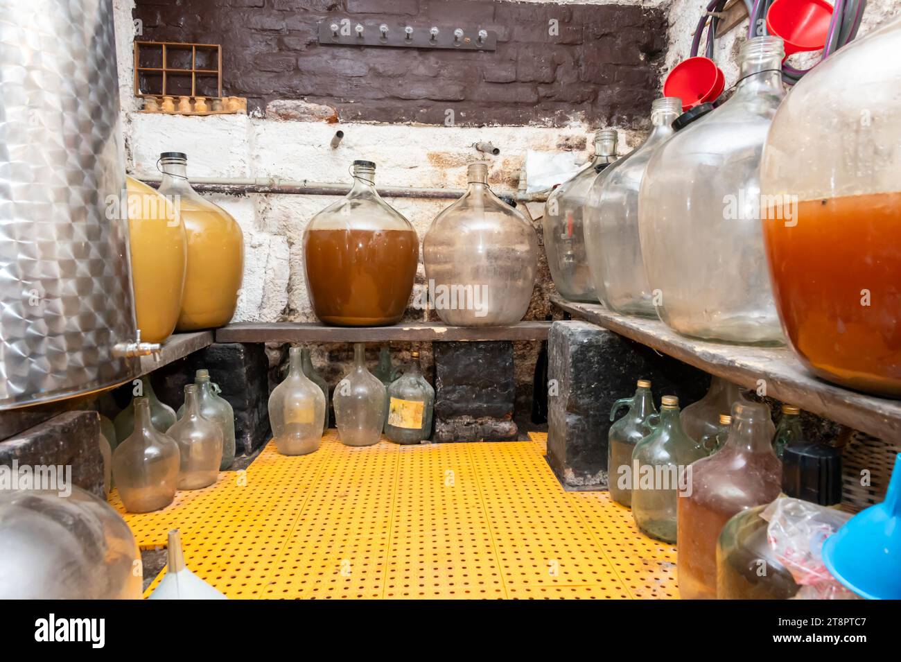 View of old fashioned wine cellar with glass storage for wine during ...