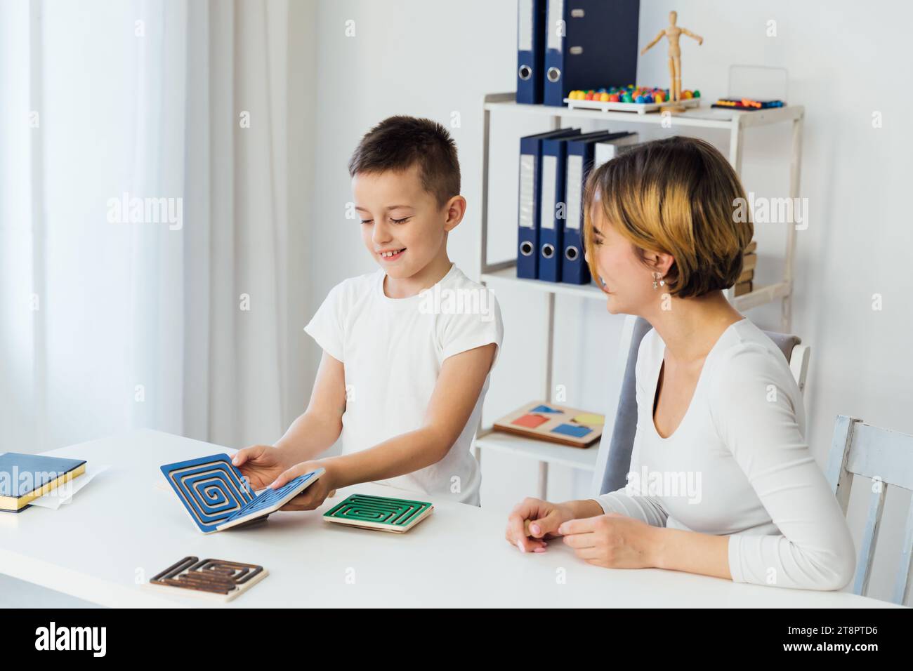 teacher with boy in school training development Stock Photo - Alamy