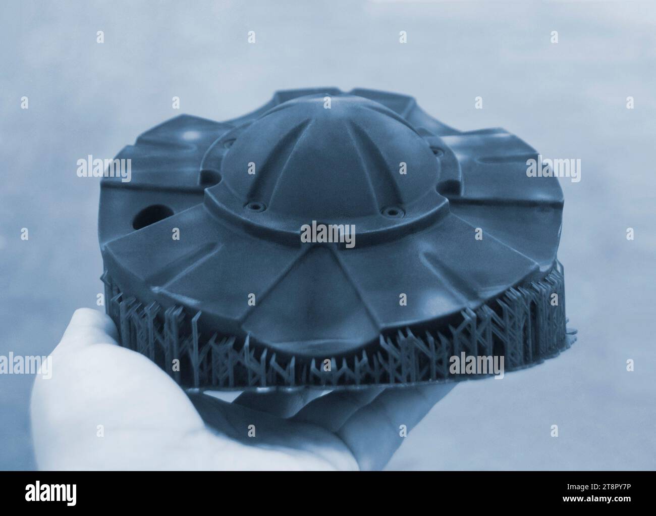 Black abstract object printed on 3D printer from photopolymer on hand ...