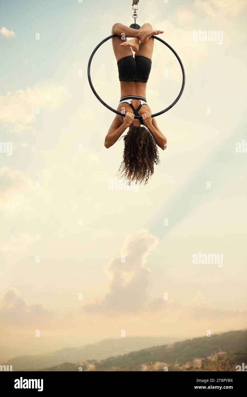 Young gymnast performing on the hoop outdoors Stock Photo - Alamy