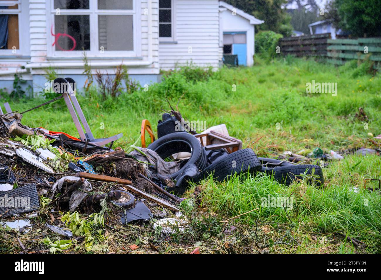 Rubbish piled up in the front yard of an abandoned residential house in ...
