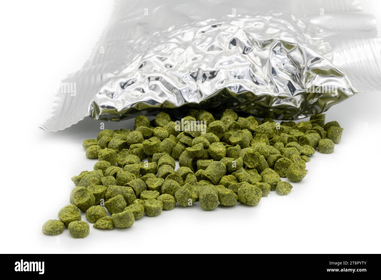 Aluminium bag with vacuumed hop granules with a pile of green hop ...
