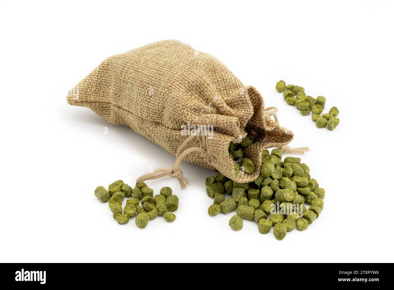 Small jute bag with pile of green hops pellets on white background ...